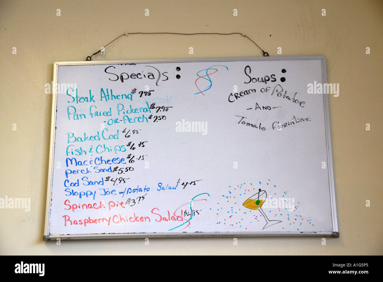 Sign of a menu of the food specials for the day hanging on a wall in a ...