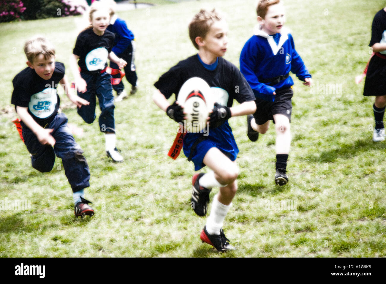 schoolboy running with rugby ball Stock Photo - Alamy
