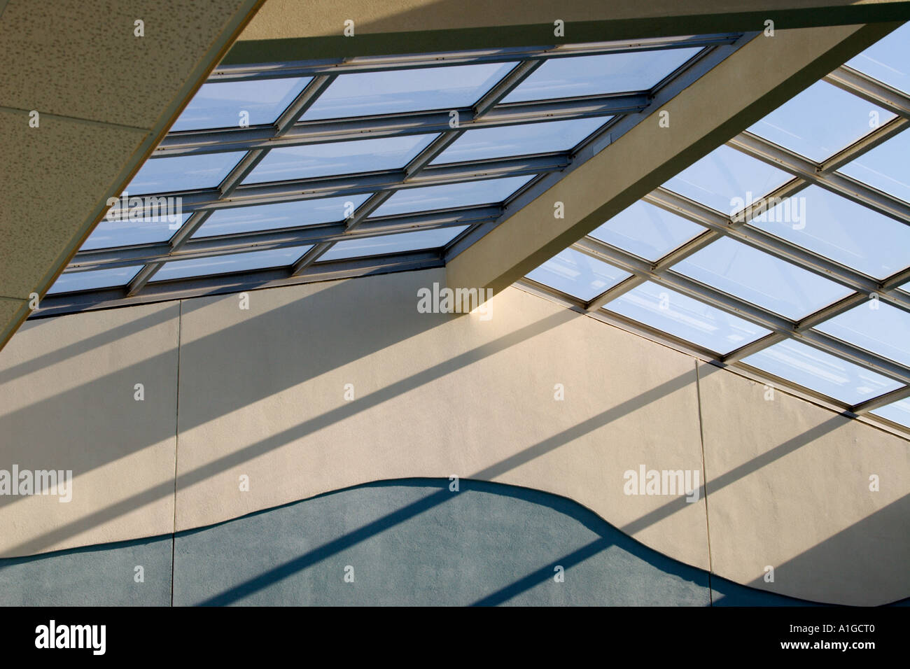 Skylight architecture with shadow patterns over swimming pool in health ...