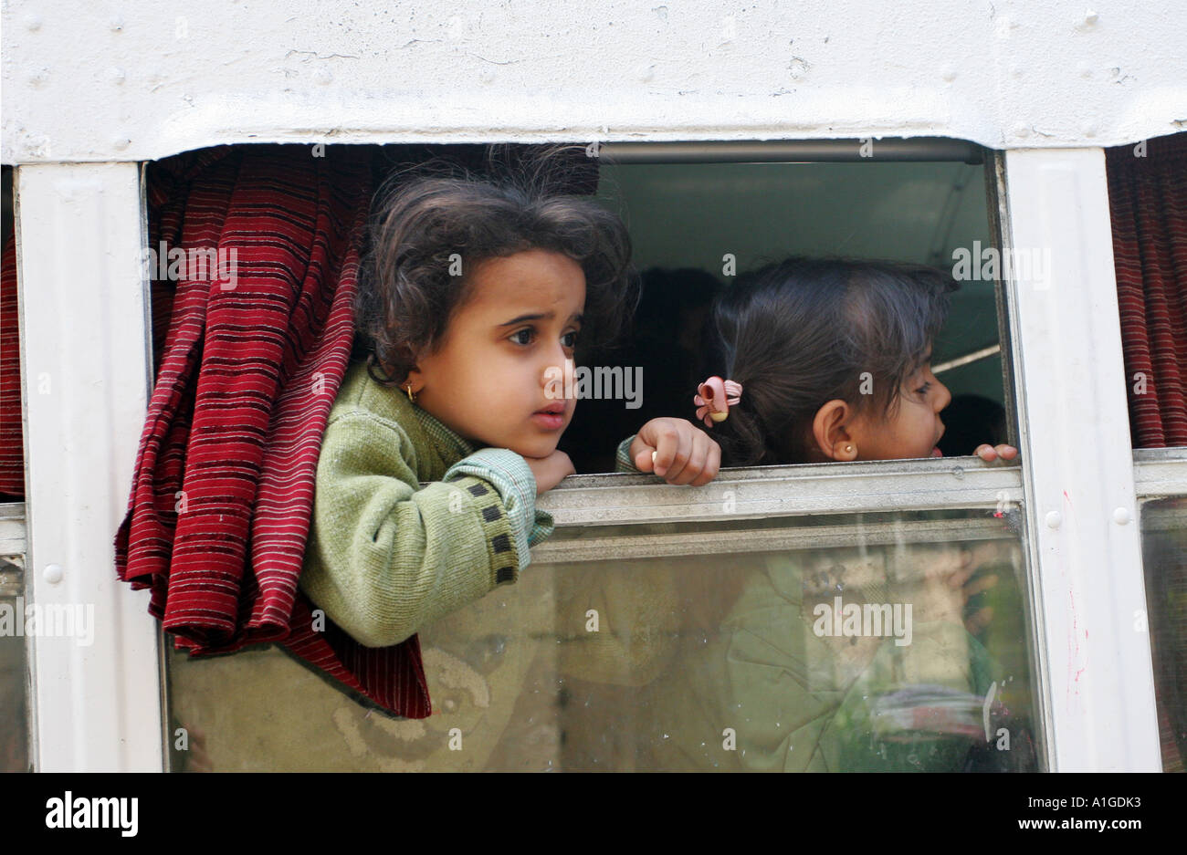 School children peer from a open window of their school bus as they ...