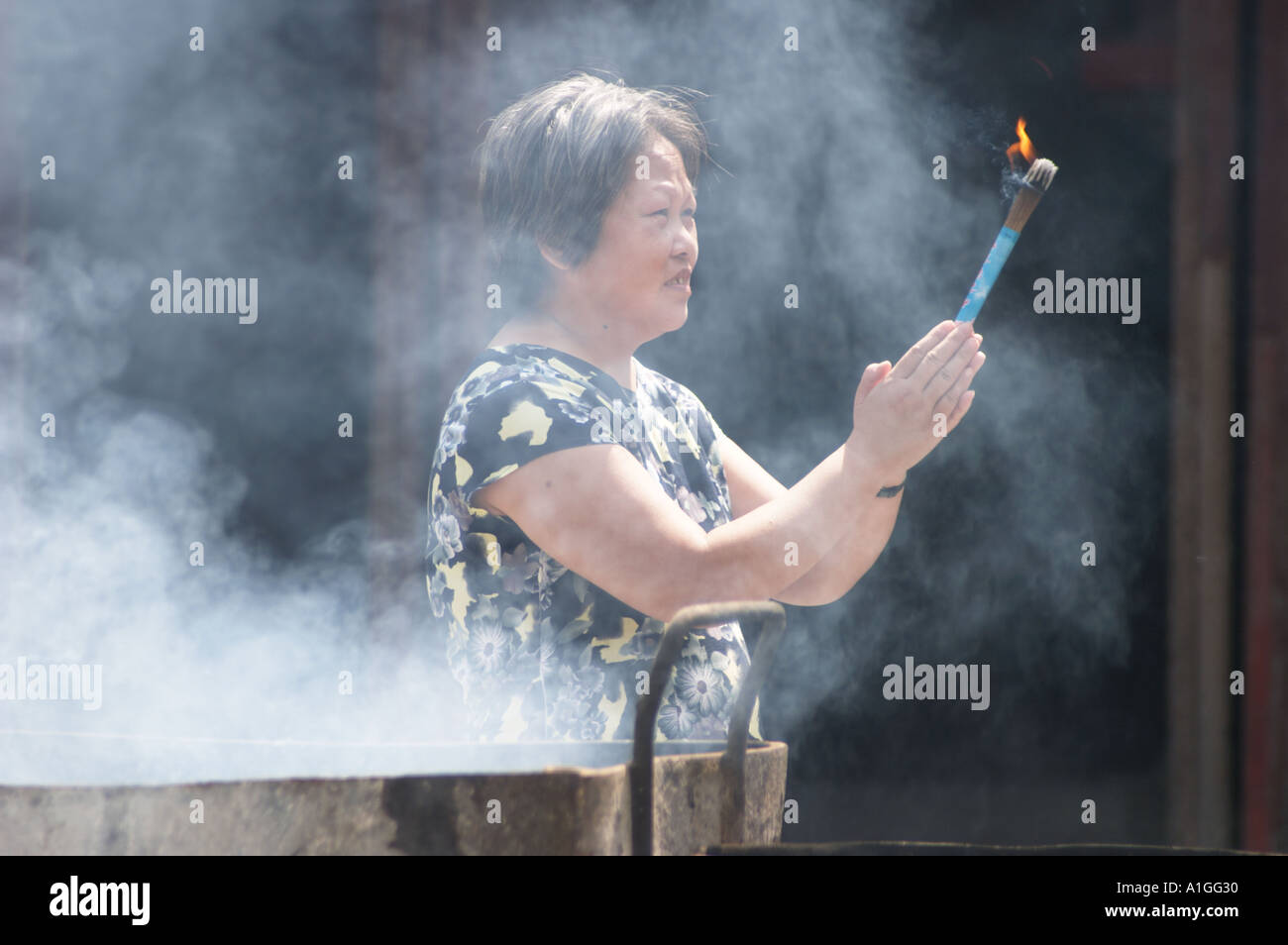 chinese woman burning incense at longhua temple shanghai china Stock ...