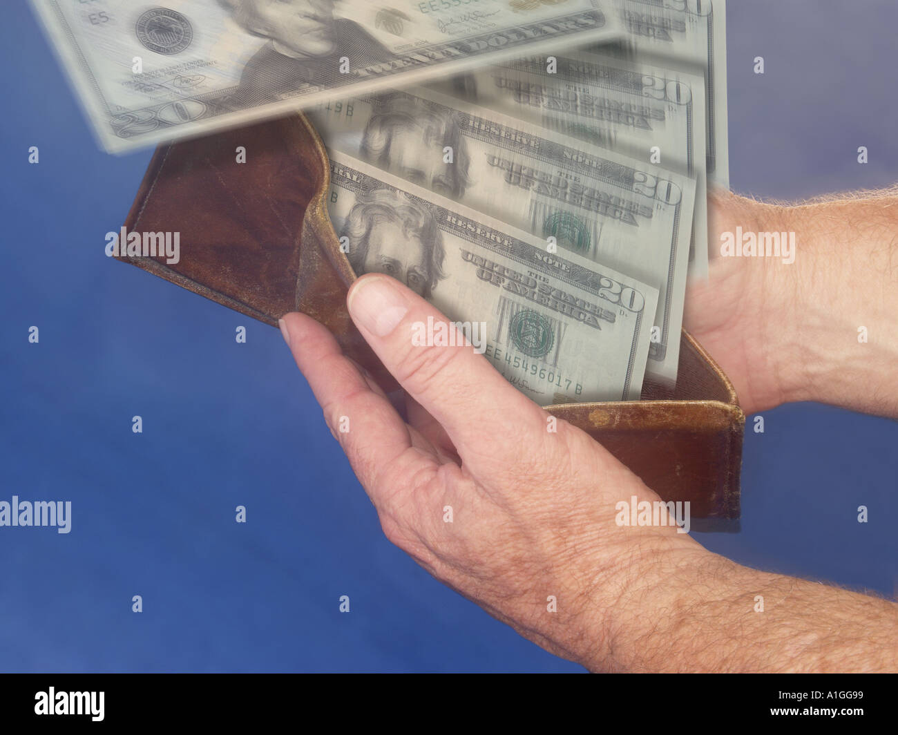 Wallet with money flying out Stock Photo - Alamy