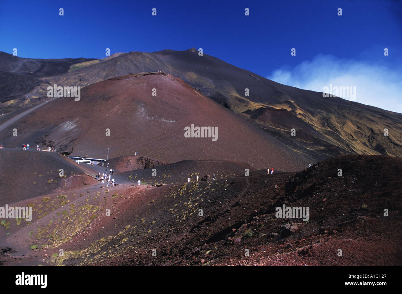 Tourists exploring the lava fields of Mount Etna after a volcanic ...