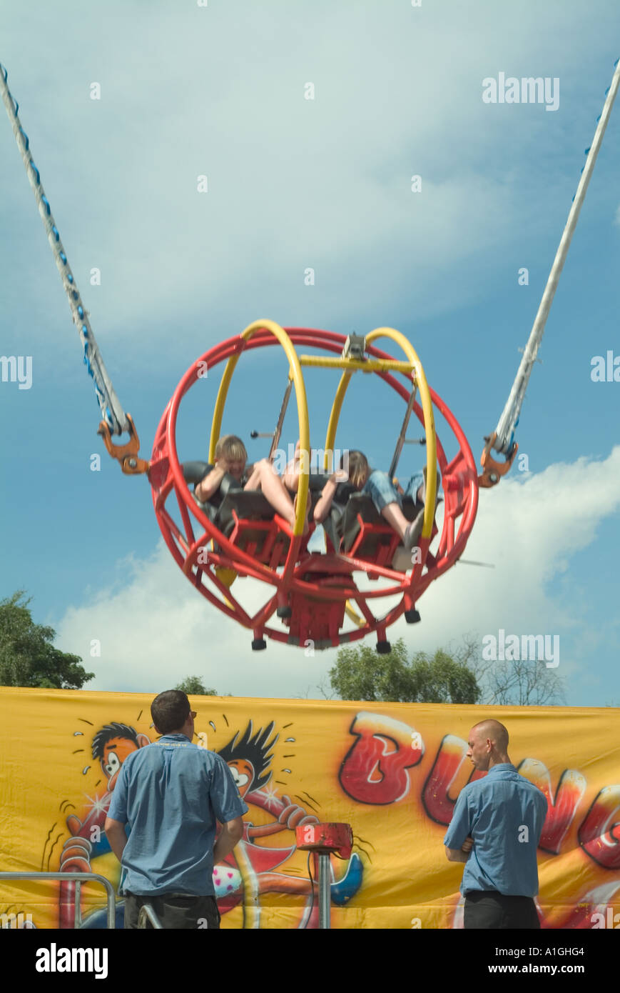Fair ground ride with two riders as it sets off on the ascent Stock ...