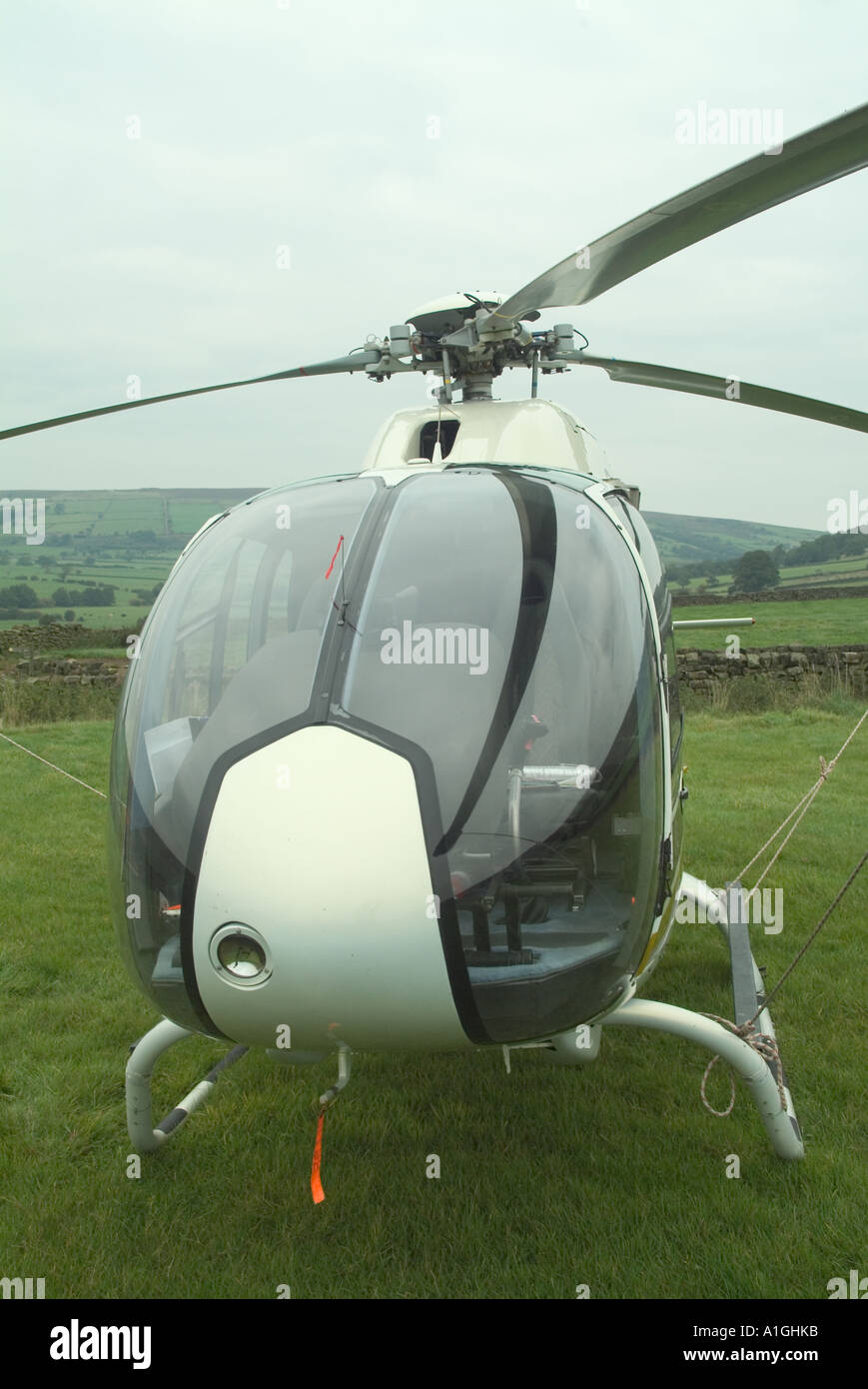 Helicopter on skids parked in a grass field in North Yorkshire Stock ...