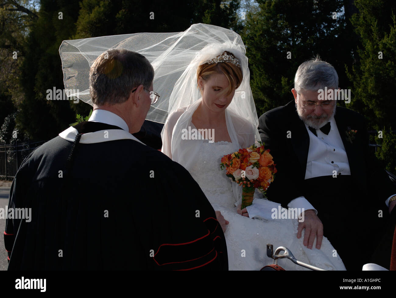 Bride with father and priest praying before the wedding ceremony Stock ...