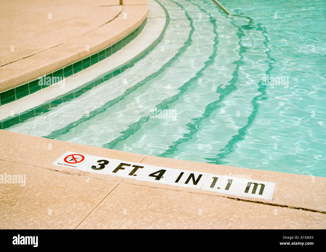 Depth sign on edge of swimming pool with water in background Stock ...