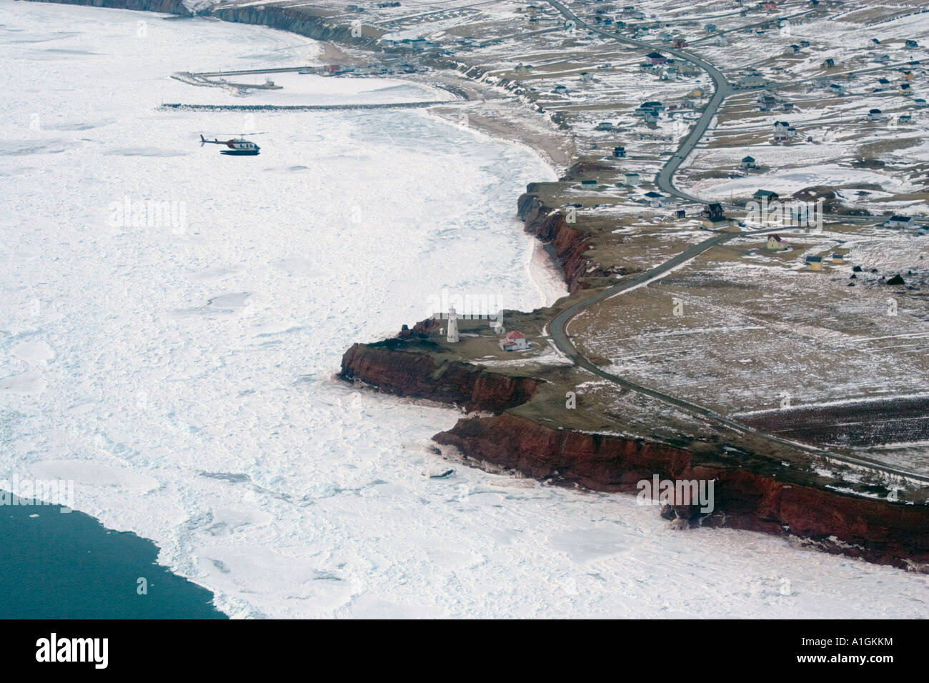 Aerial view of ice along coastline of Magdalen Islands with lighthouse ...