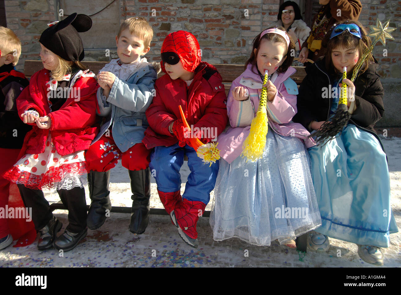 A row of costumed kids waiting for Carnivale festivities to begin ...