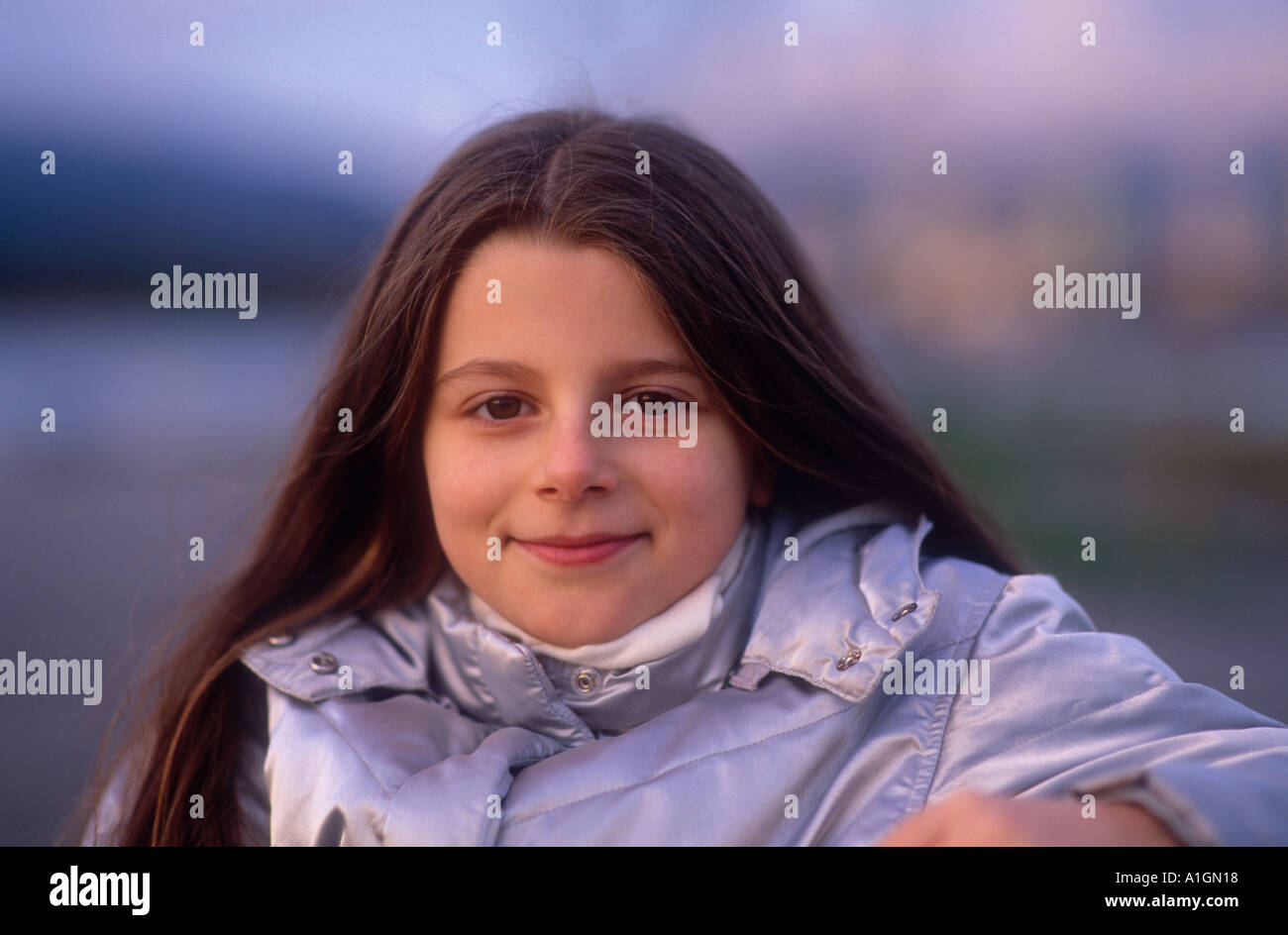 outdoor portrait of a 9 nine years old girl smiling at the camera Stock Photo - Alamy
