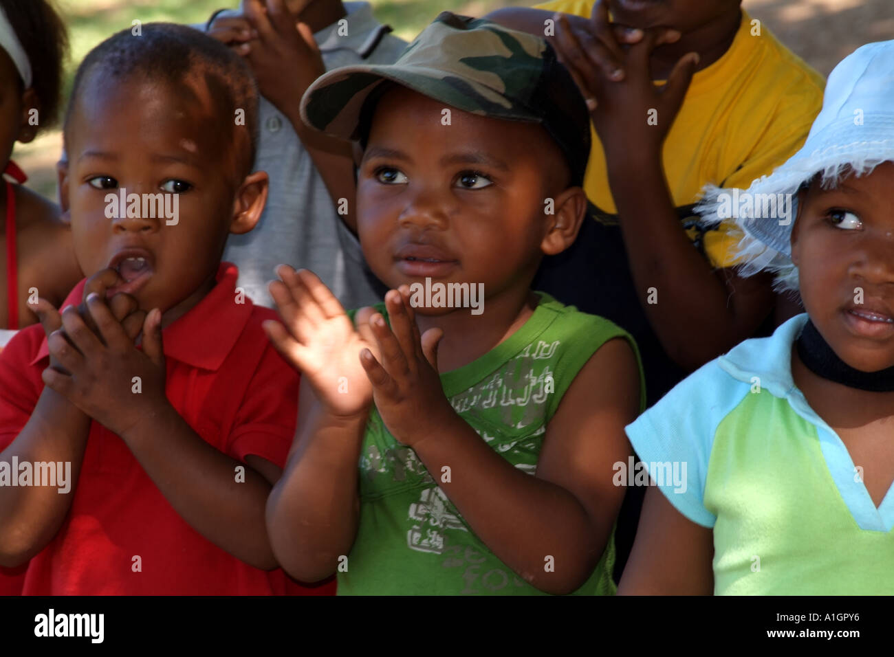 Little boy clapping during morning prayers Stock Photo - Alamy