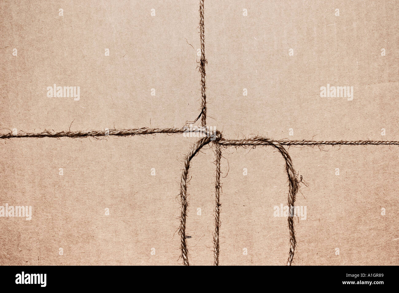 Parcel And Knotted Strings Stock Photo - Alamy