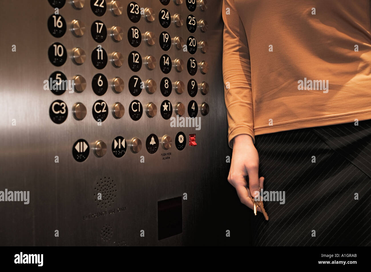 Woman In Elevator Holding Keys Stock Photo - Alamy