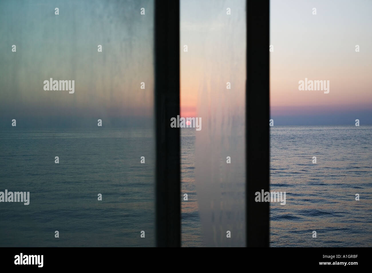 View Thru Windows On Sunset Over Ocean Stock Photo - Alamy