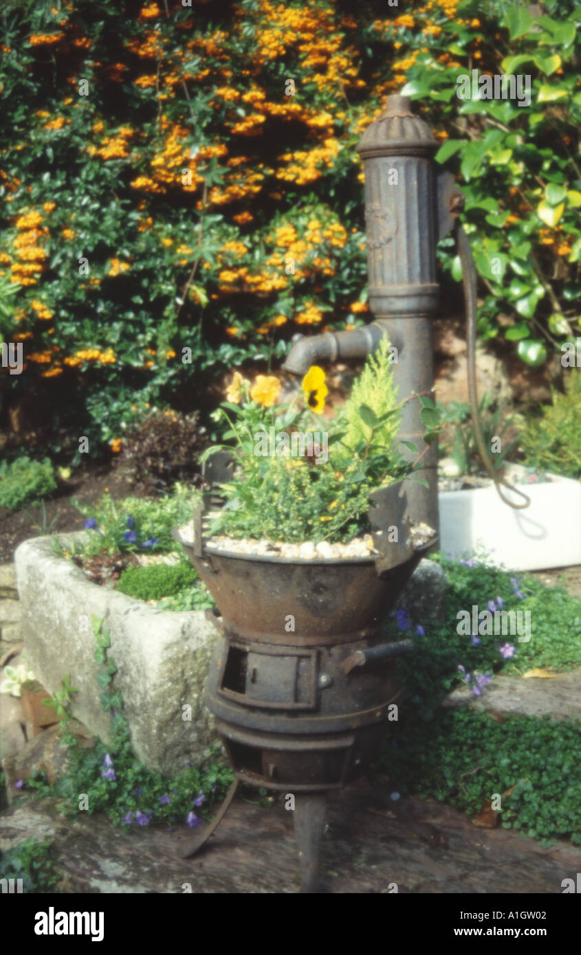 Old water standpipe surrounded by flowers Stock Photo - Alamy
