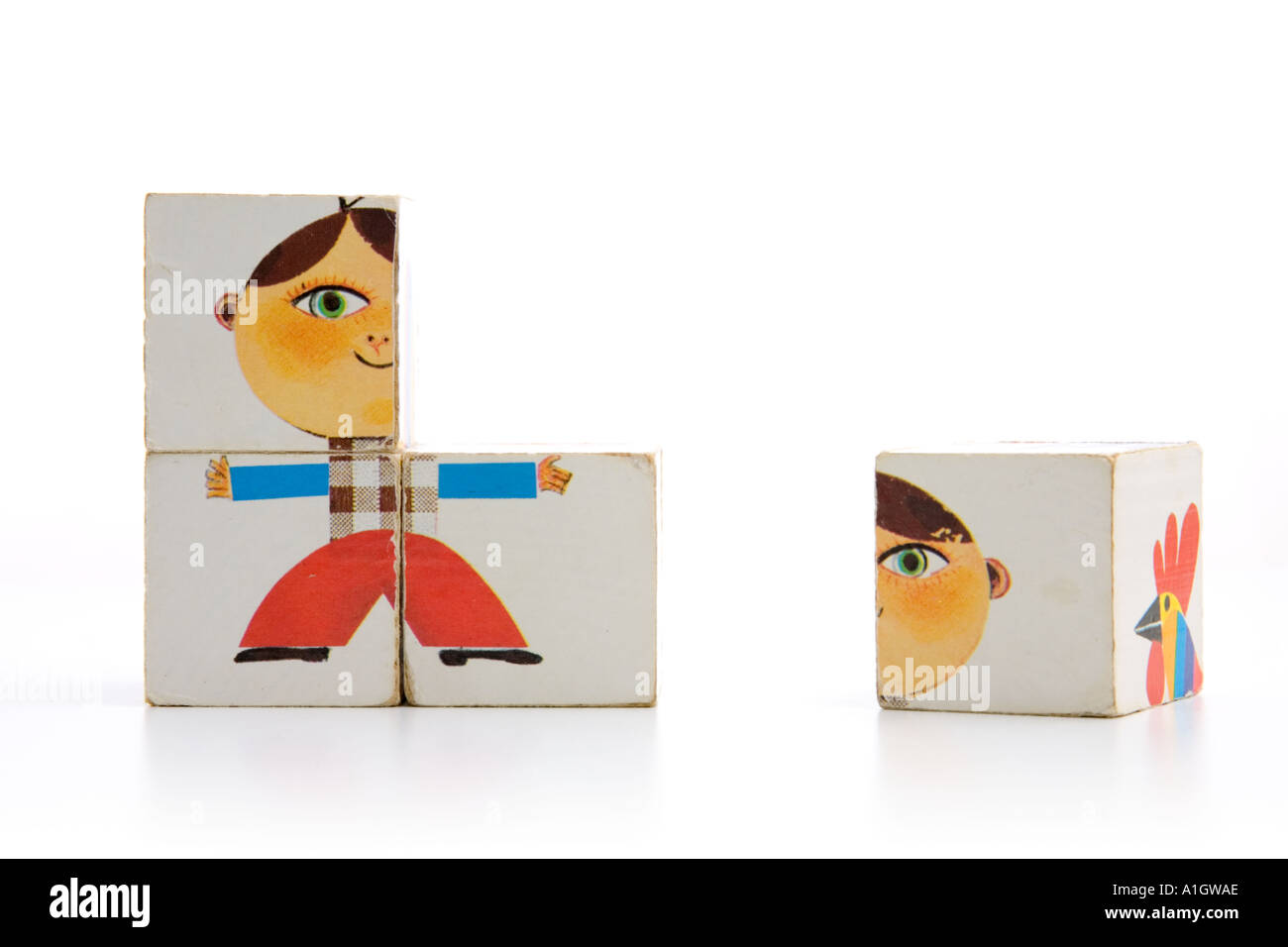 Childs building blocks with graphic of a man head piece on the floor ...