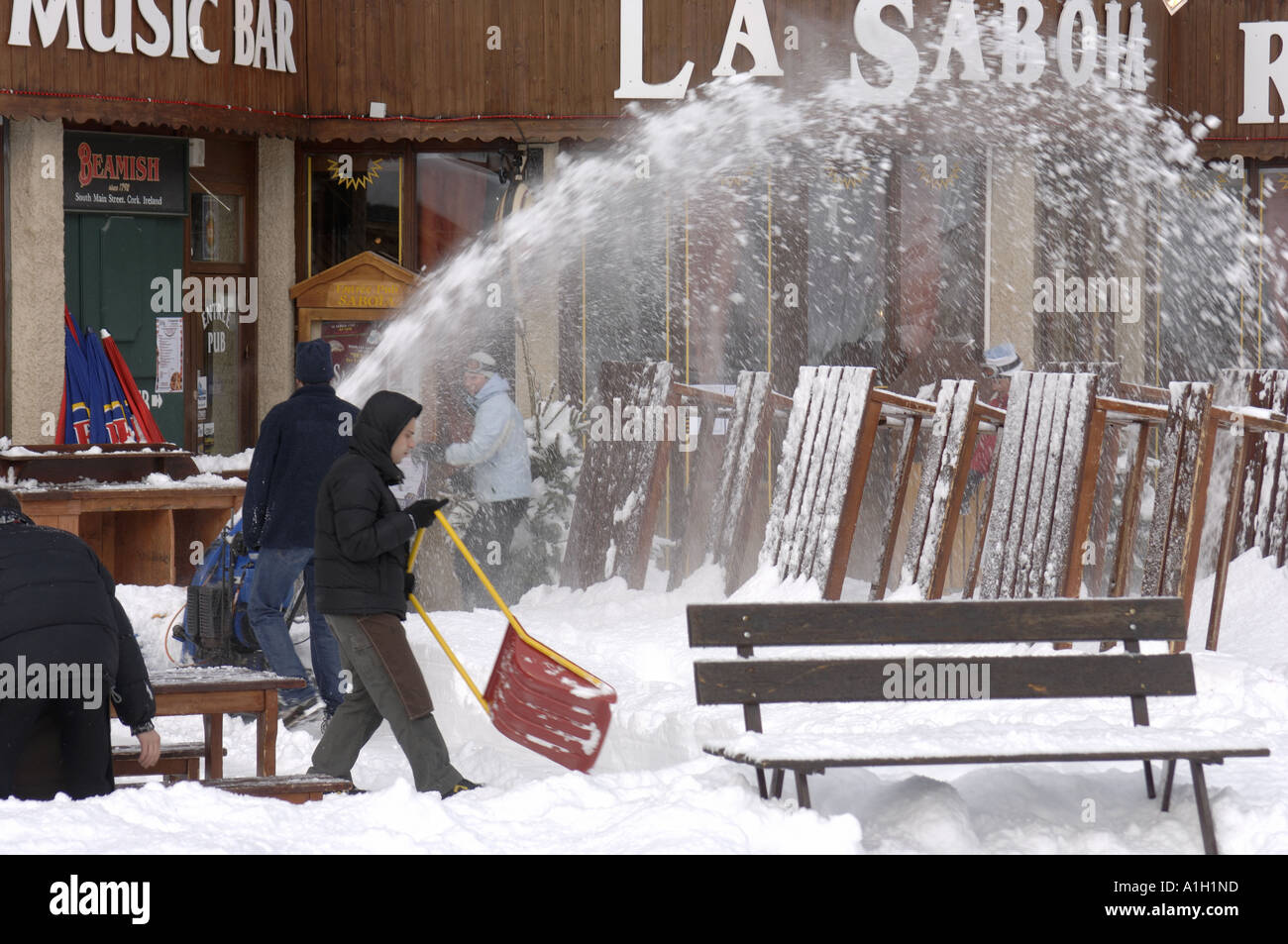 mini snow plough clearing snow from village street in the french alps ...
