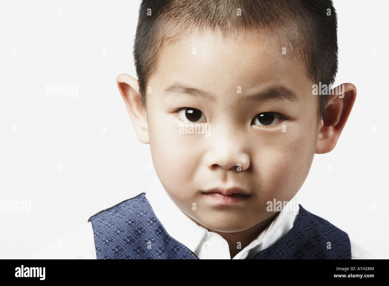 Portrait of a boy looking serious Stock Photo - Alamy
