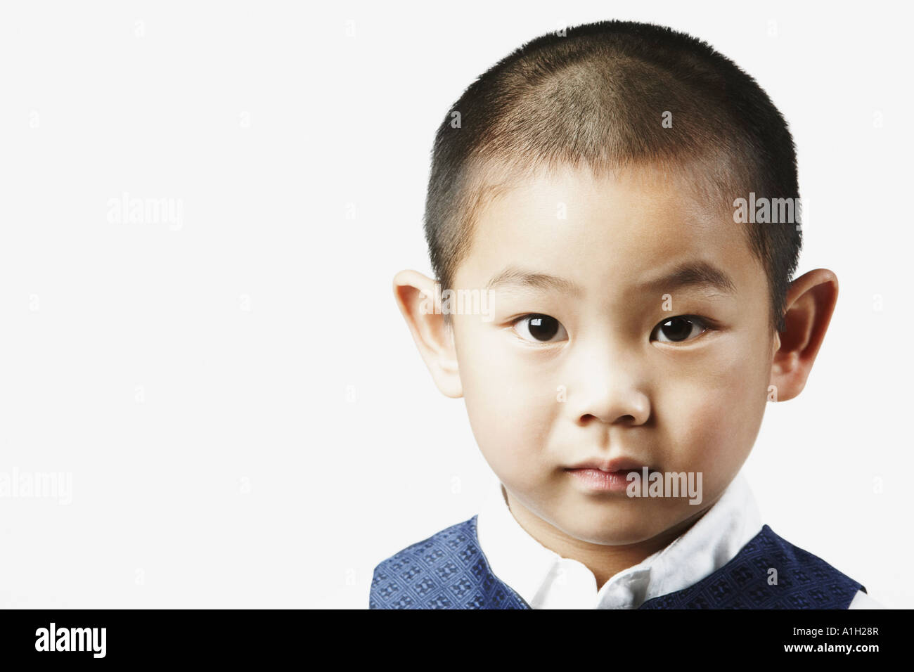 Portrait of a boy looking serious Stock Photo - Alamy