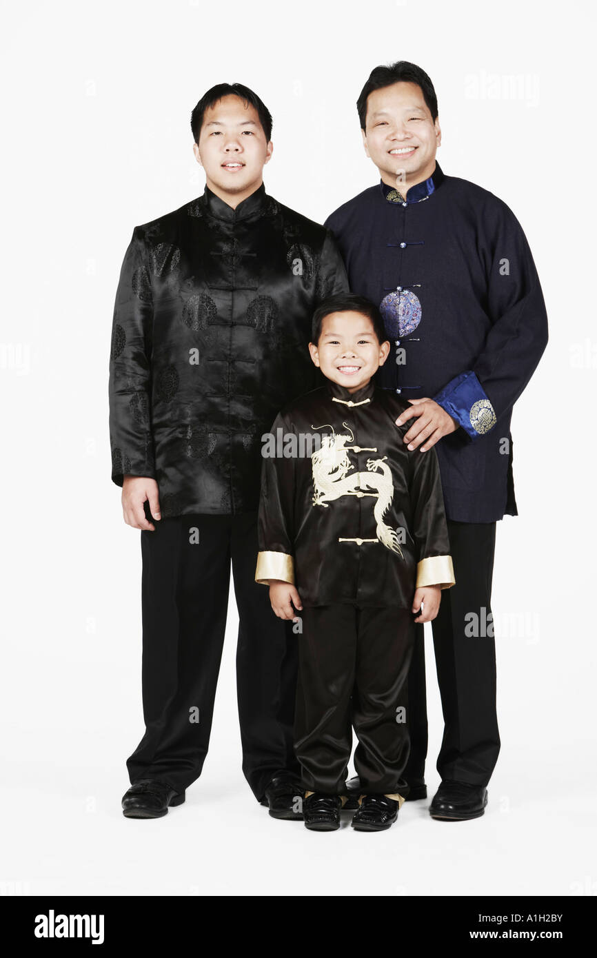 Portrait of a father standing with his two sons Stock Photo - Alamy