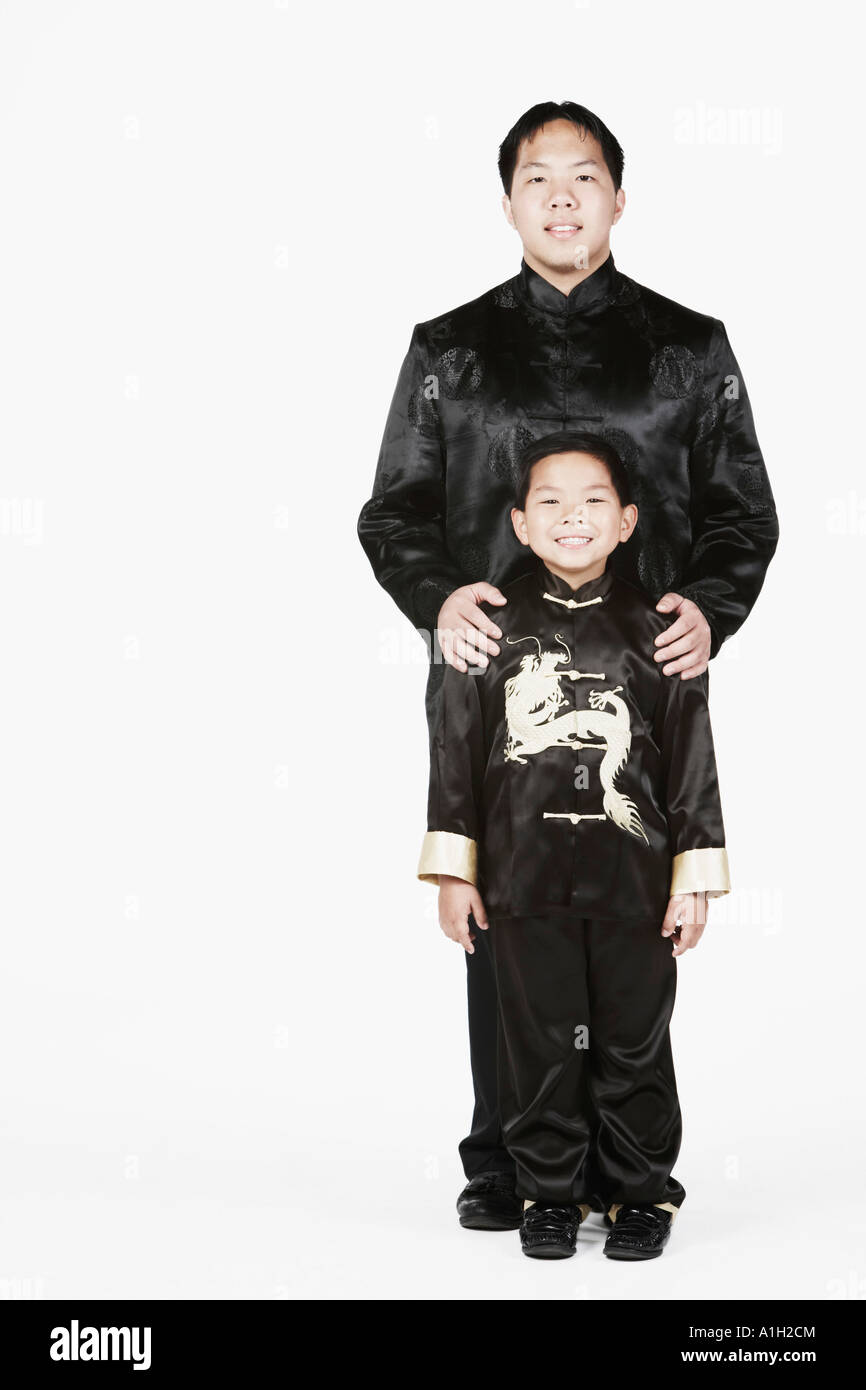 Portrait of a teenage boy standing with his brother Stock Photo - Alamy