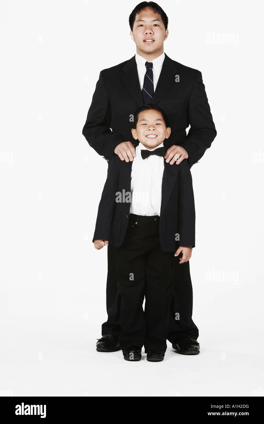 Portrait of two brothers standing together smiling Stock Photo - Alamy