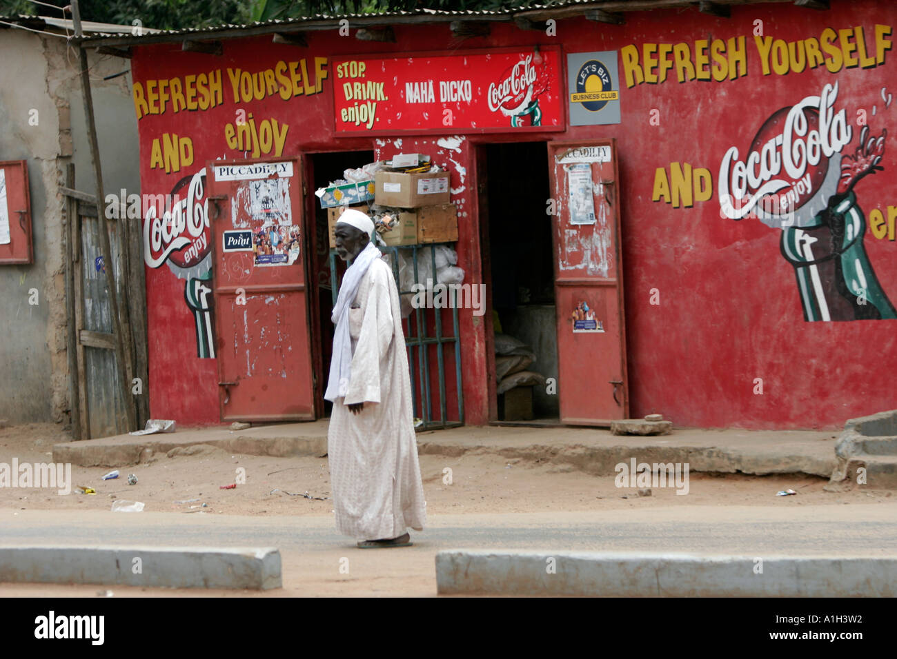 Gambian man in robe outside store Bakau The Gambia Stock Photo - Alamy