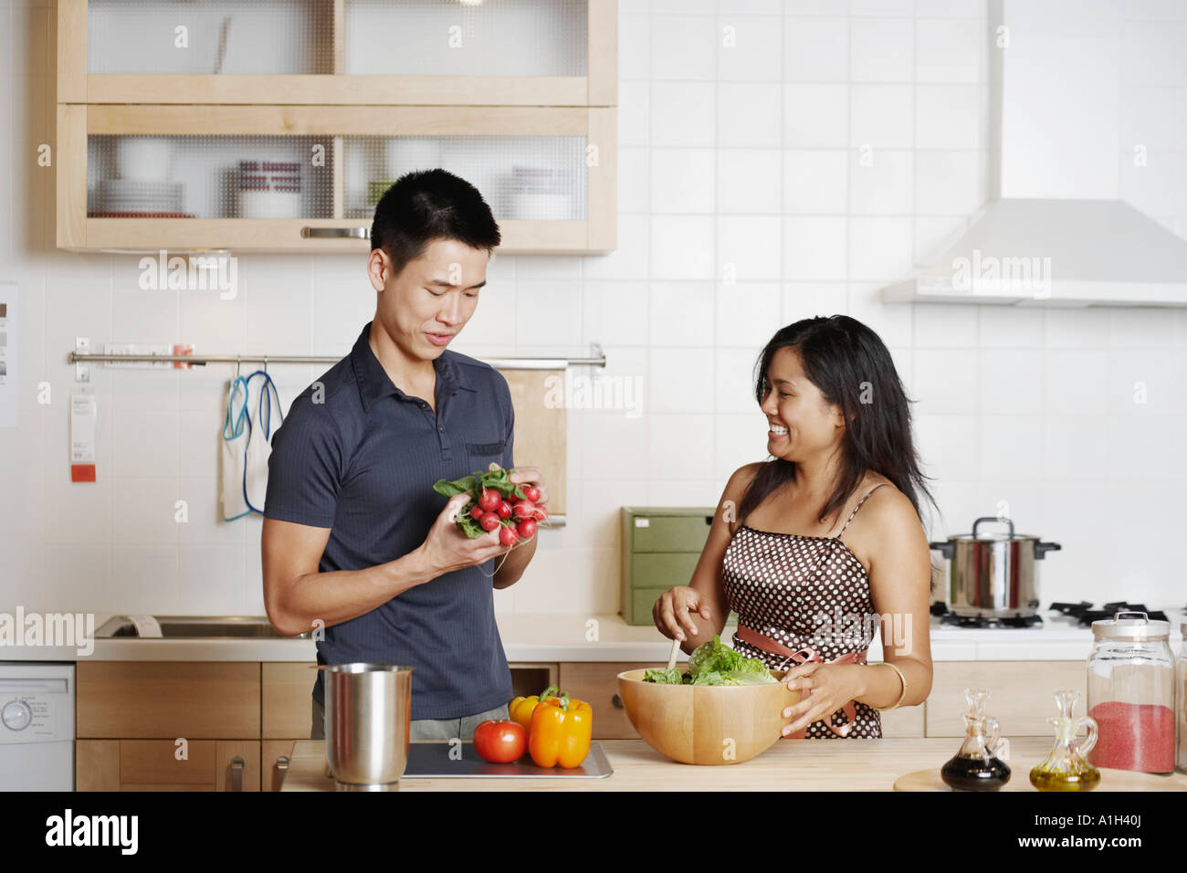 Close-up of a young man and a young woman standing and holding root ...