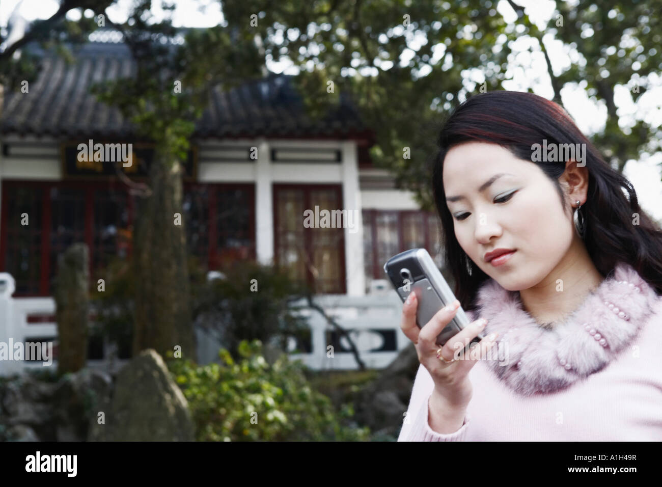 Close-up of a young woman looking at a mobile phone Stock Photo - Alamy