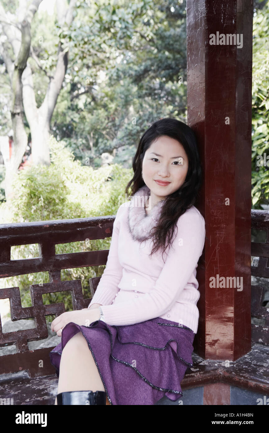 Portrait of a young woman sitting Stock Photo - Alamy