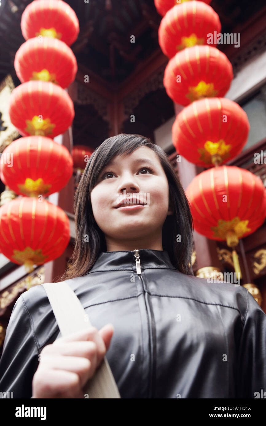 Close-up of a young woman standing in front of a Chinese lantern Stock ...