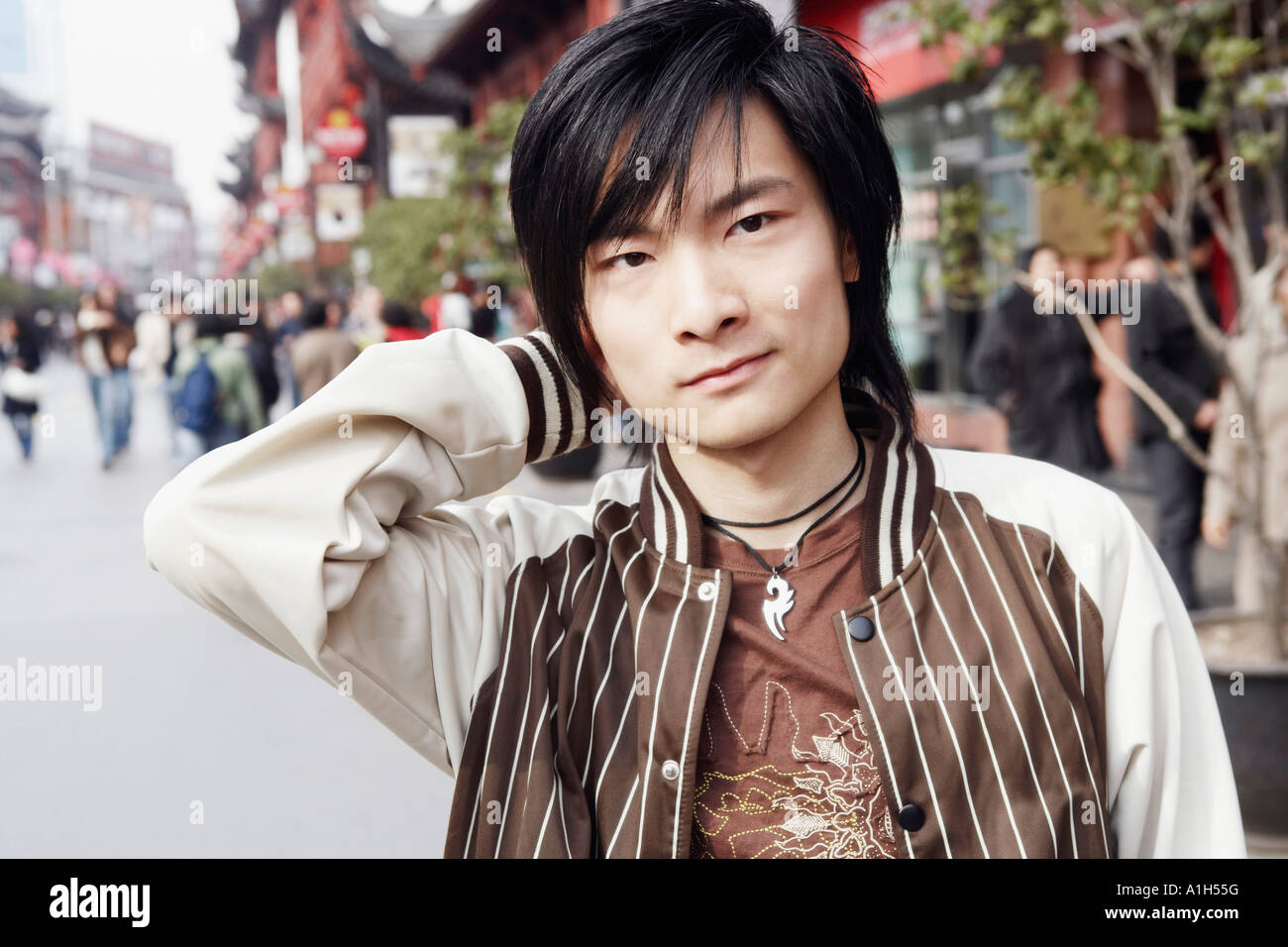 Portrait of a young man smirking Stock Photo - Alamy