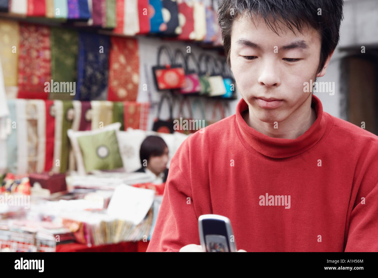 Close-up of a young man using a mobile phone Stock Photo - Alamy