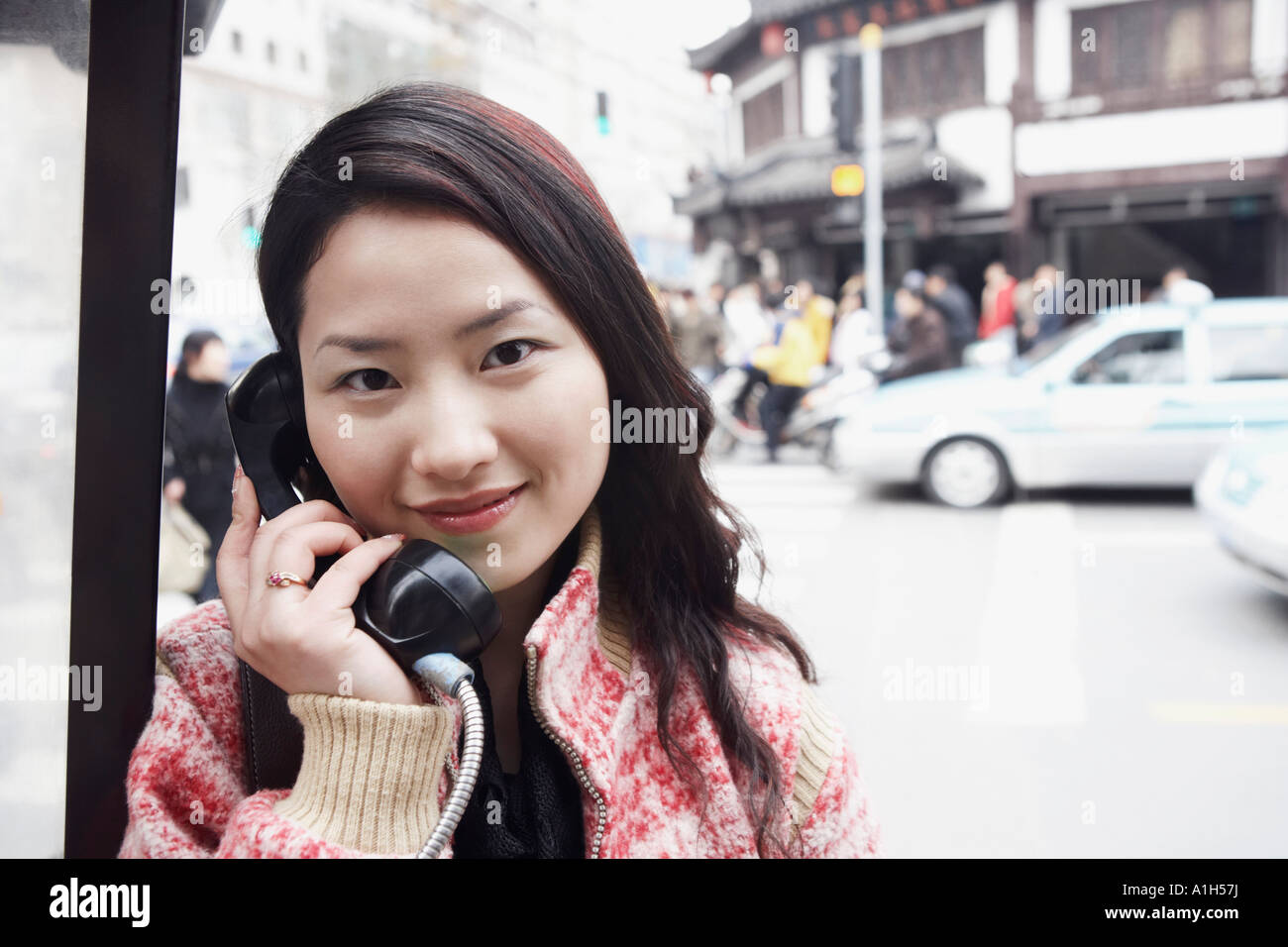 Portrait of a young woman using a telephone Stock Photo - Alamy