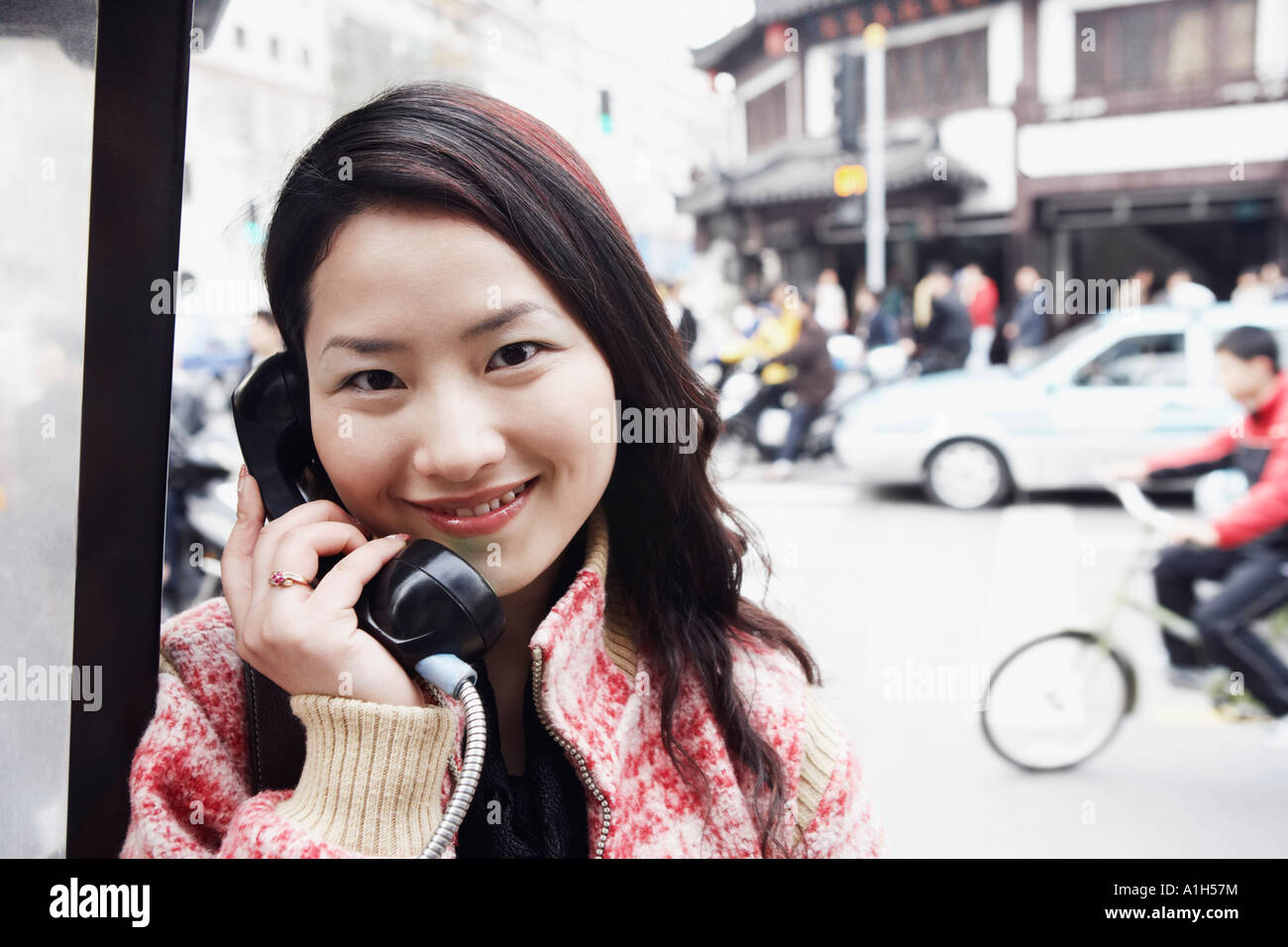 Portrait of a young woman using a telephone Stock Photo - Alamy