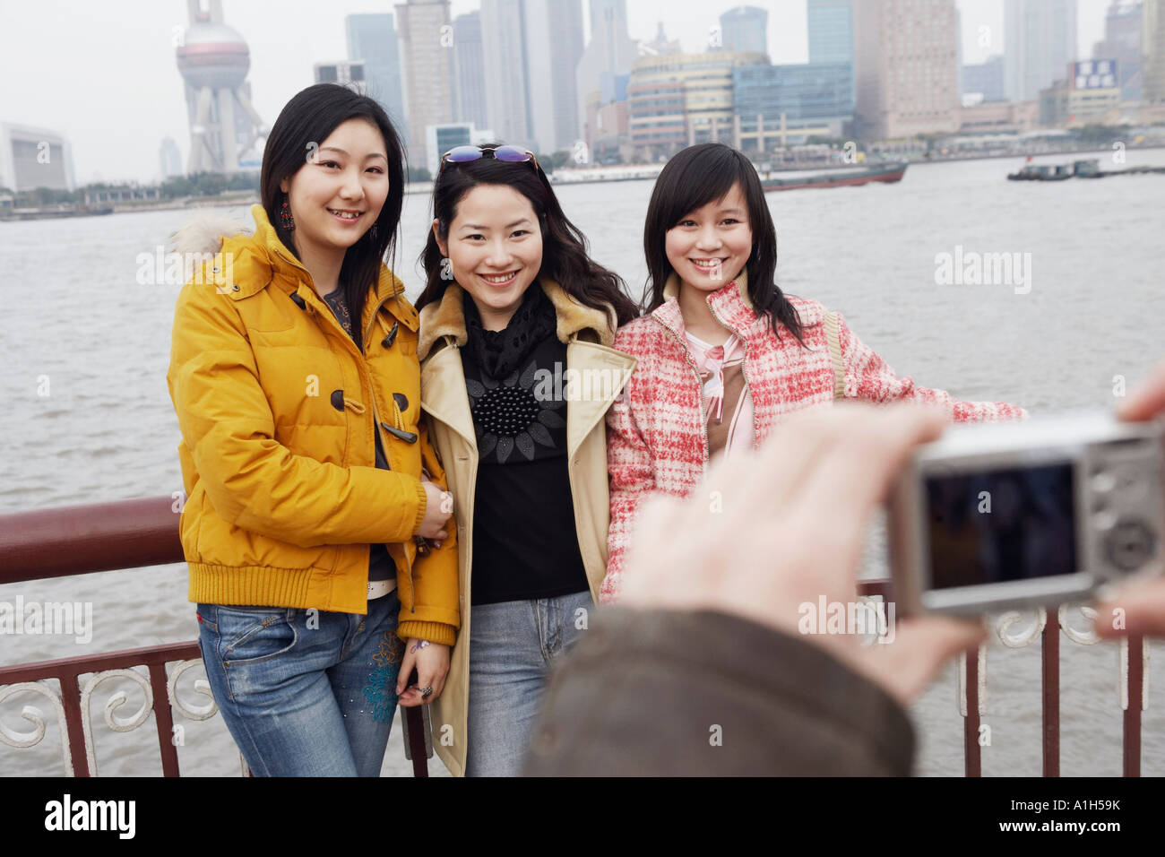 Three young women posing Stock Photo - Alamy