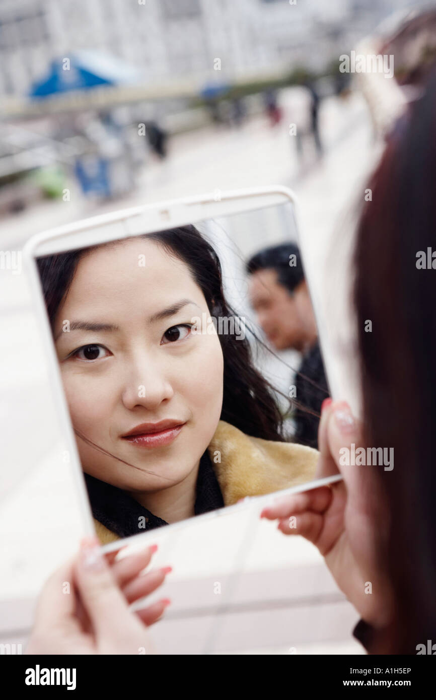 Reflection of a young woman in the mirror Stock Photo - Alamy