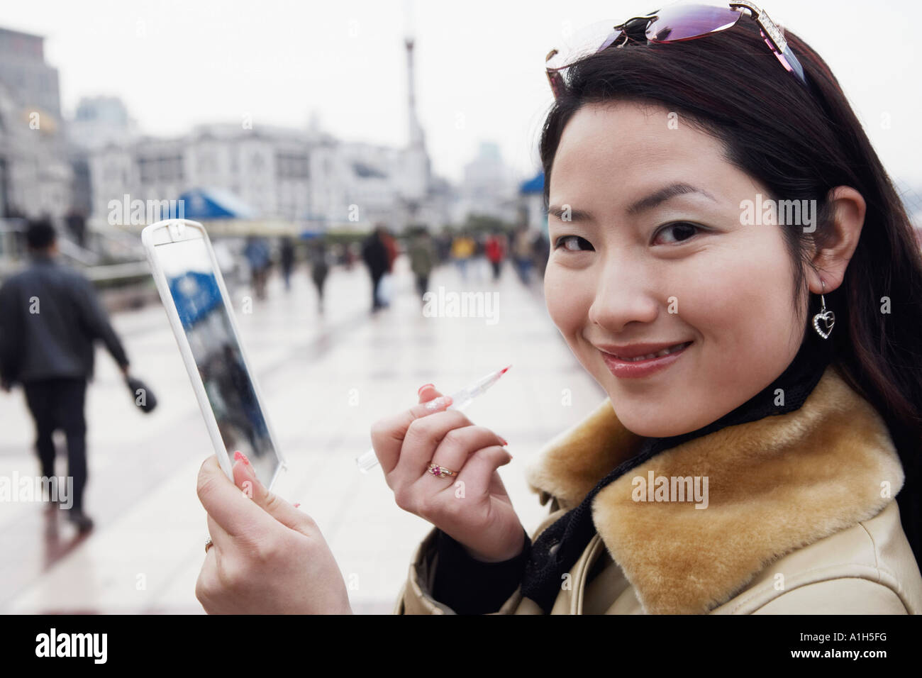 Side profile of a young woman holding a mirror smiling Stock Photo - Alamy