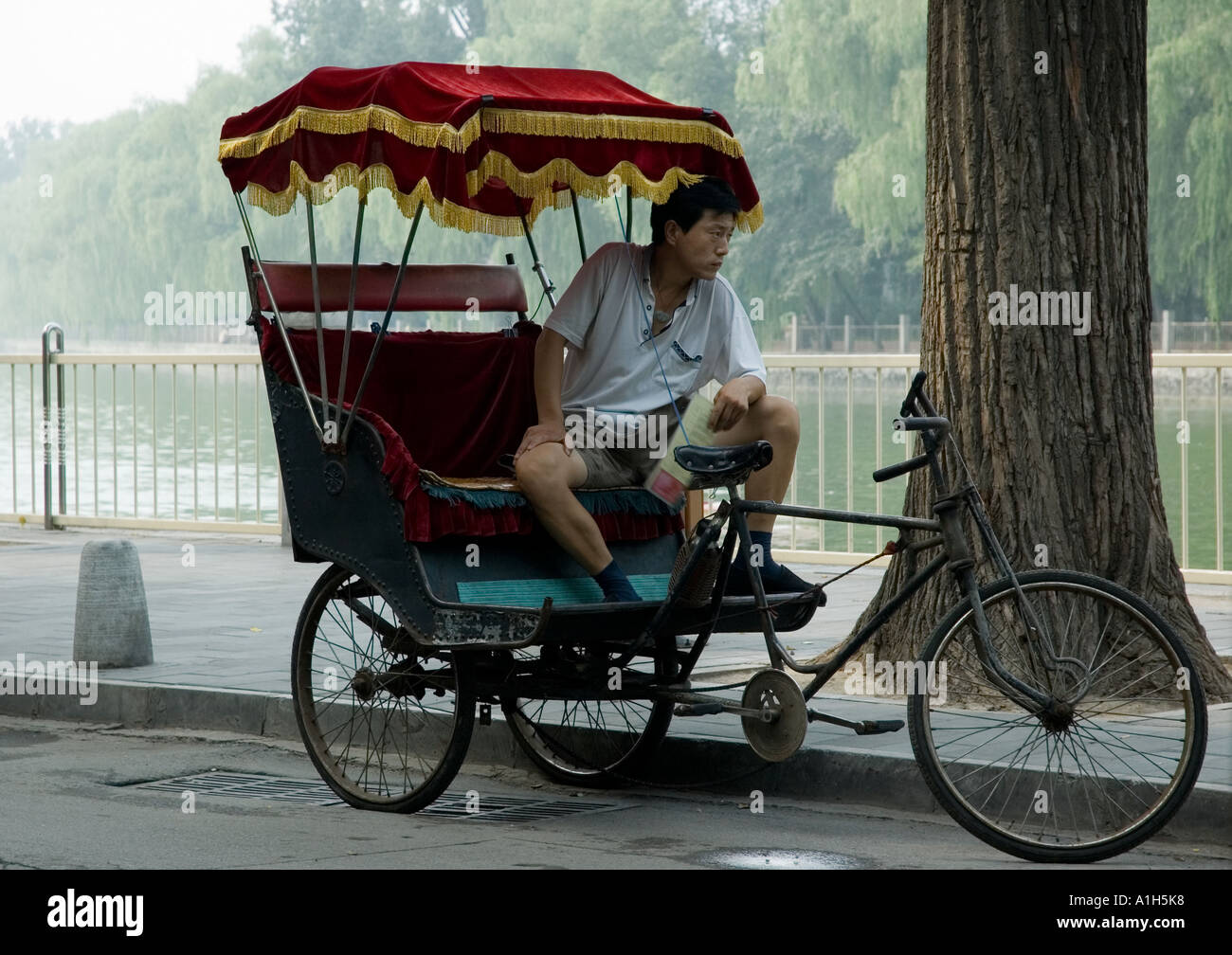 Man sitting on his rickshaw in Beihai park, Beijing, China Stock Photo ...
