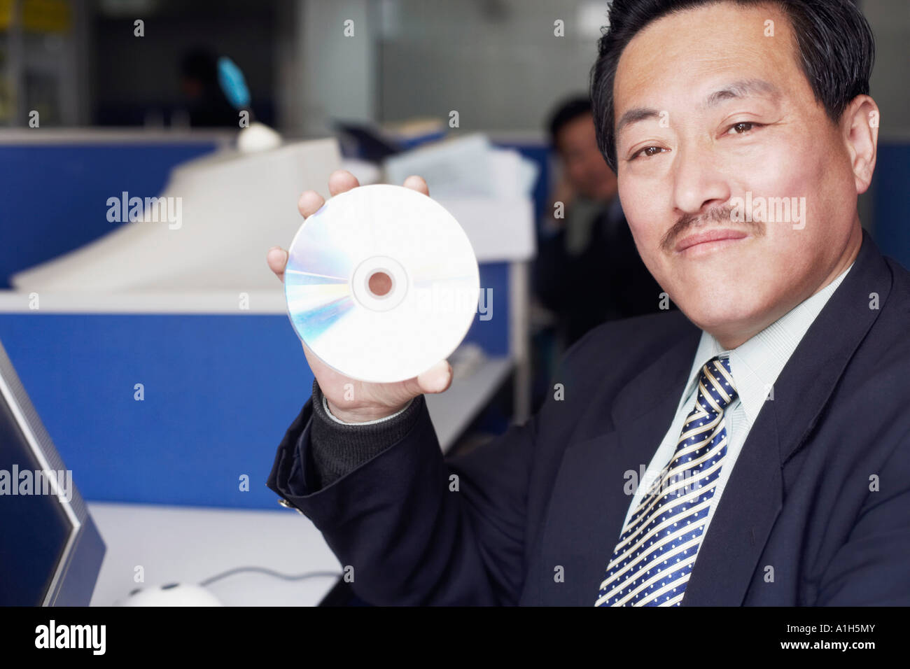 Portrait of a businessman showing a CD Stock Photo - Alamy