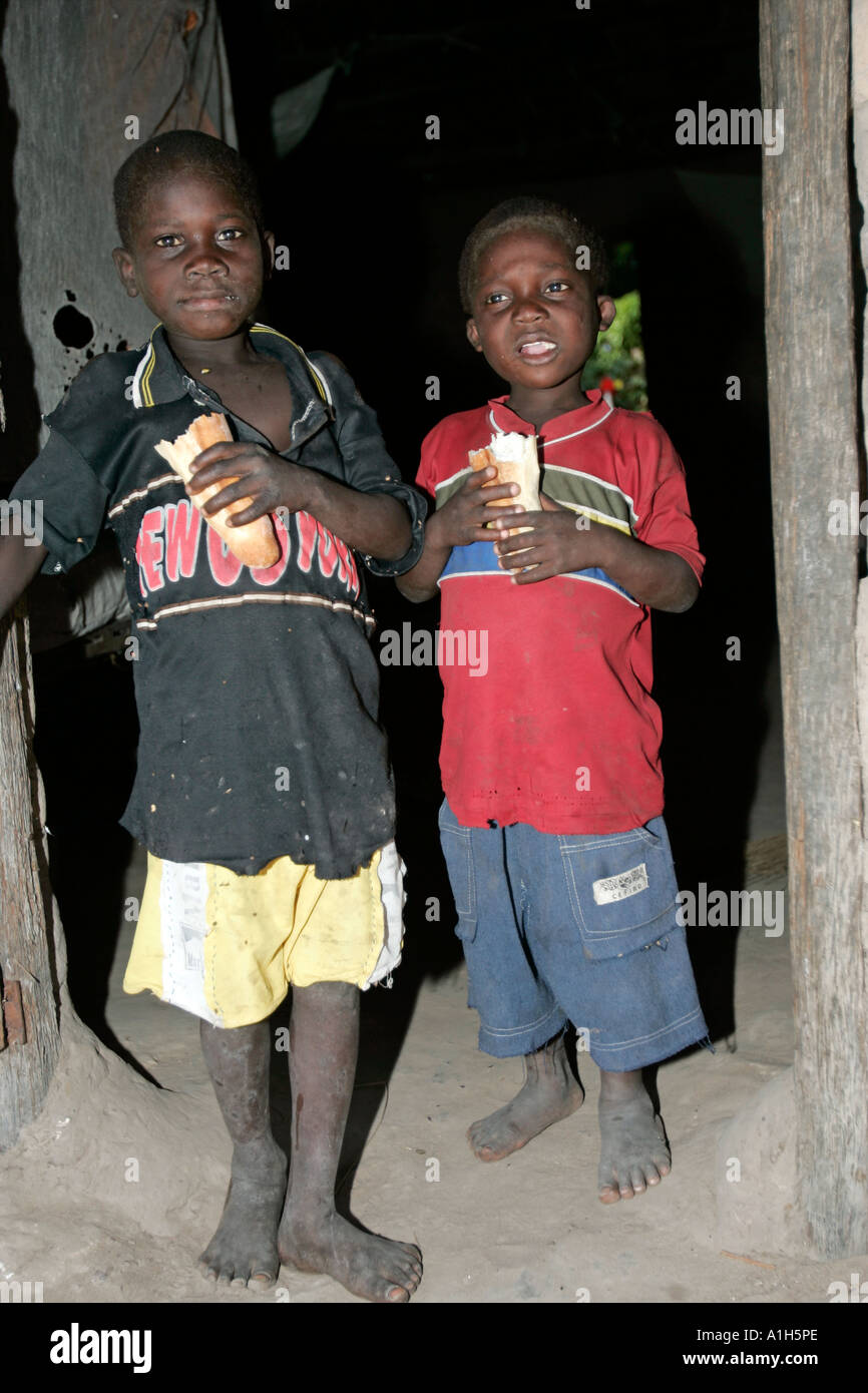 Two young boys eat bread in doorway Berending village south of The ...
