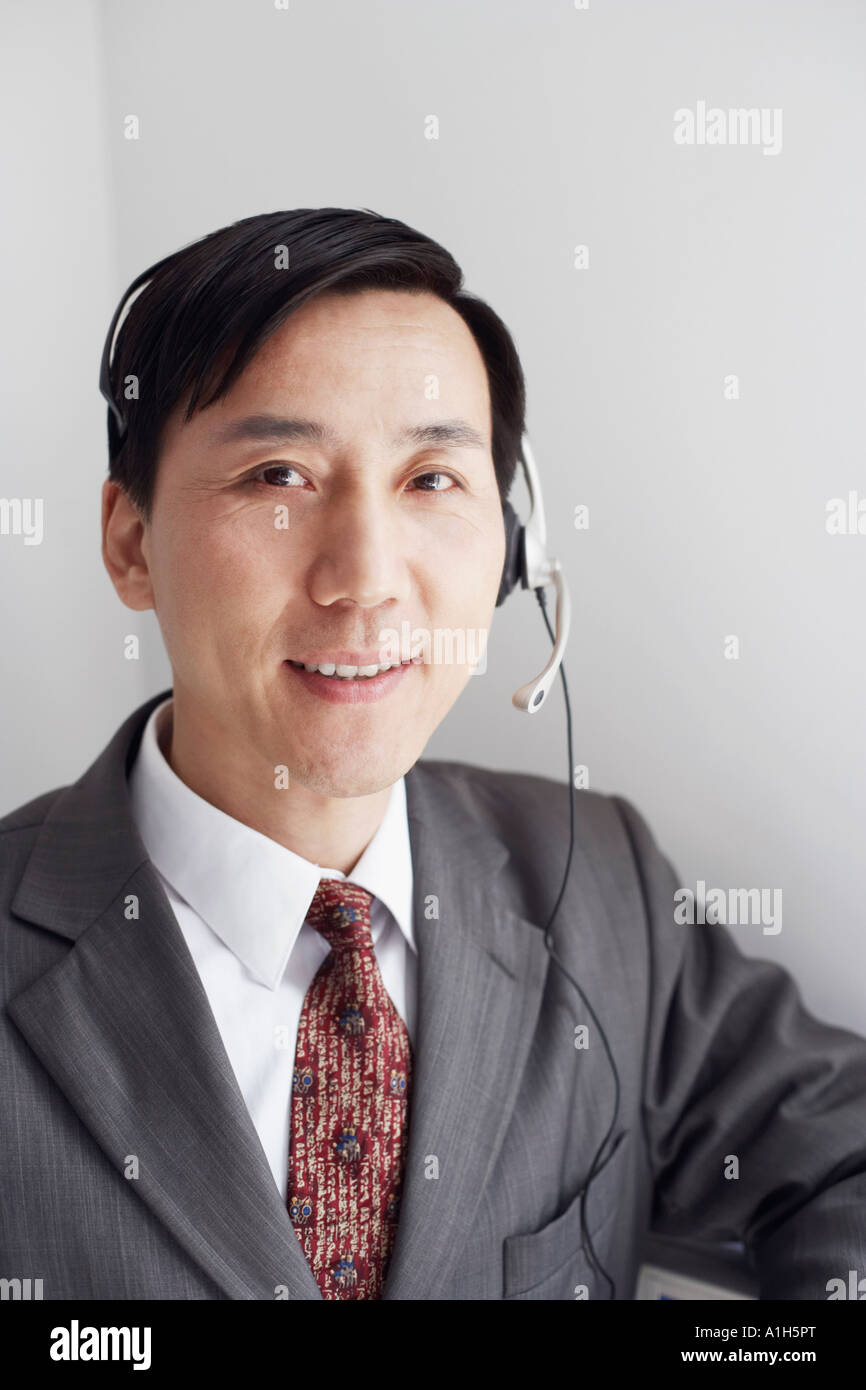 Portrait of a customer service representative wearing a headset smiling ...