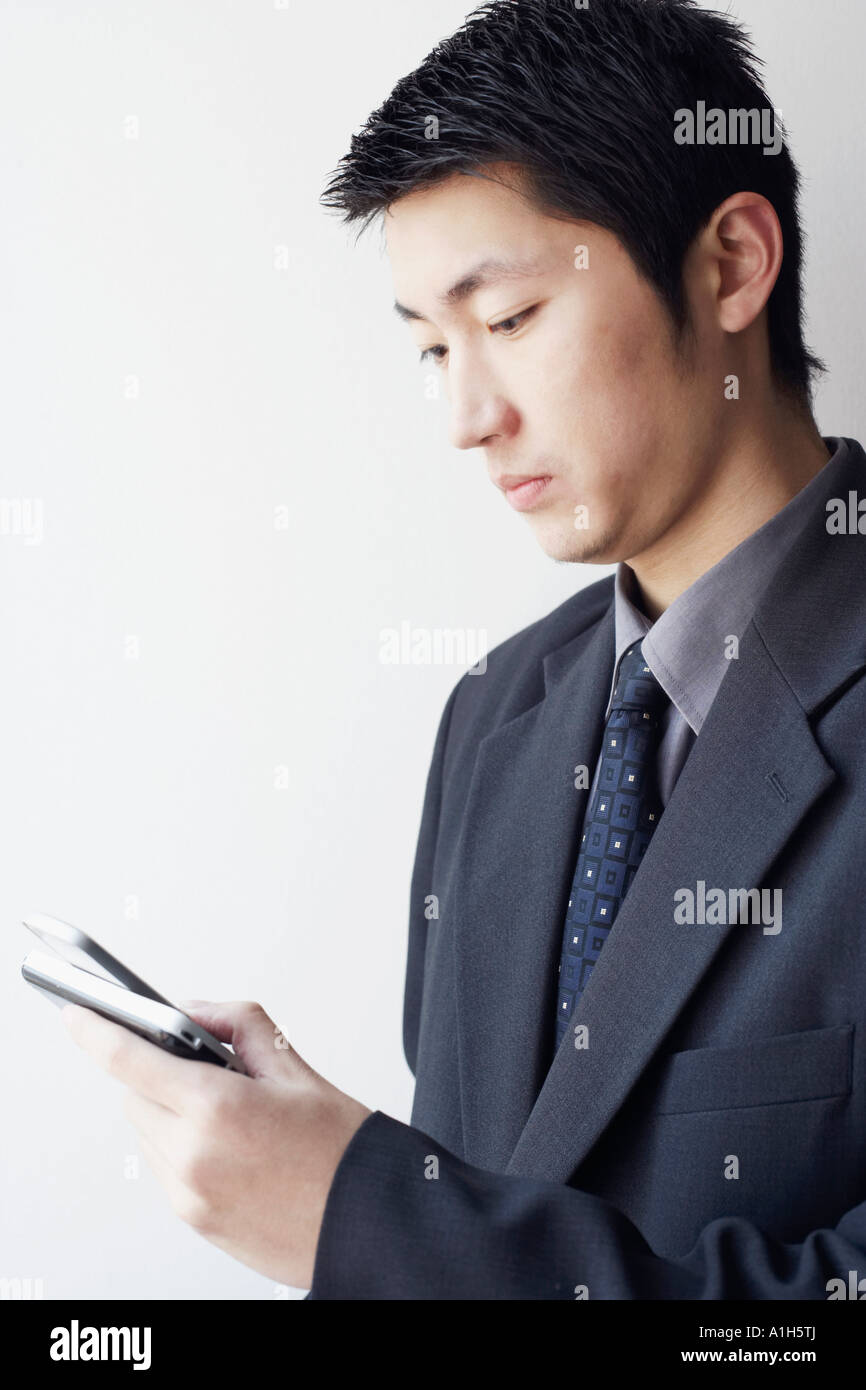 Close-up of a businessman looking at a mobile phone Stock Photo - Alamy