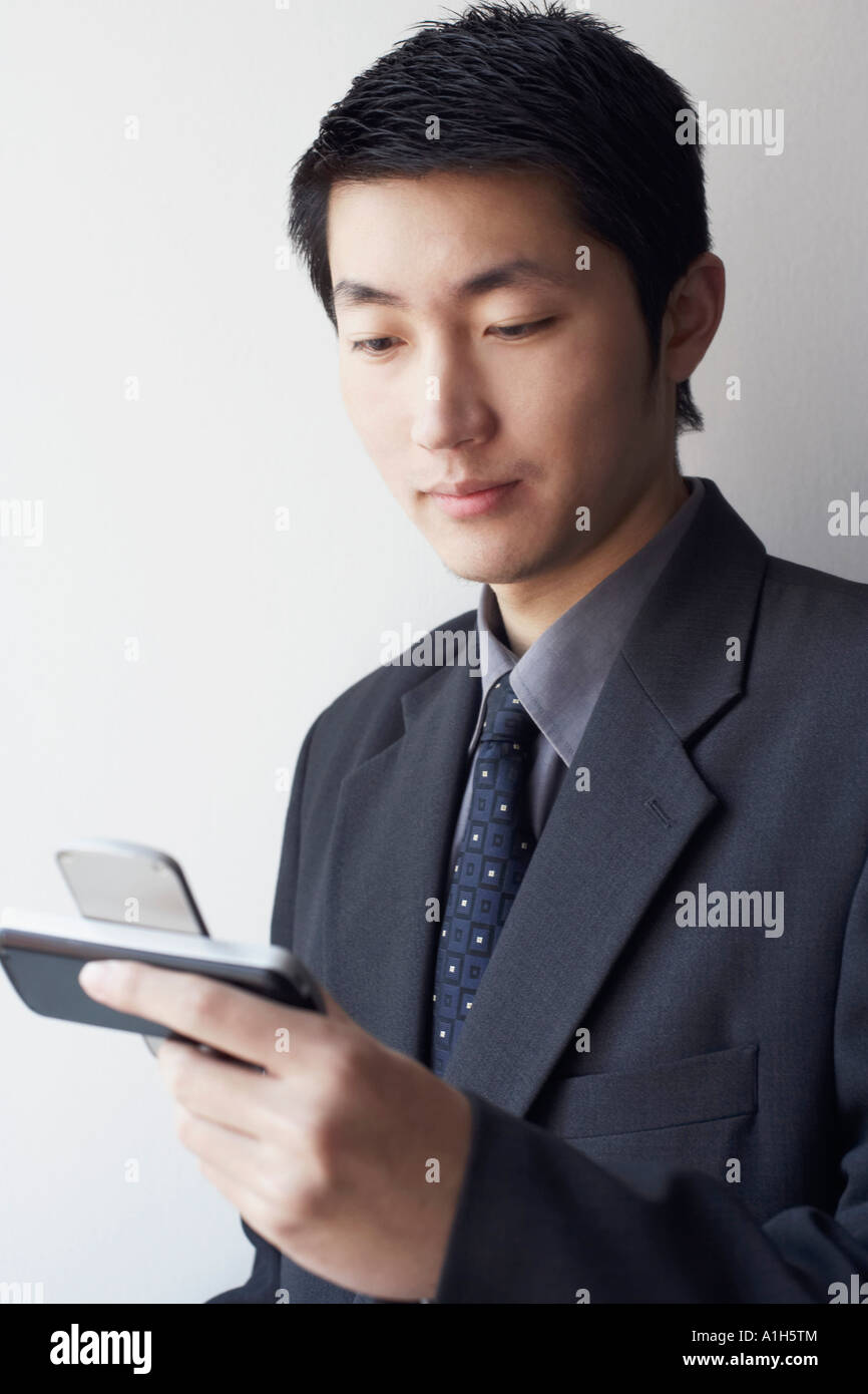 Close-up of a businessman looking at a mobile phone Stock Photo - Alamy