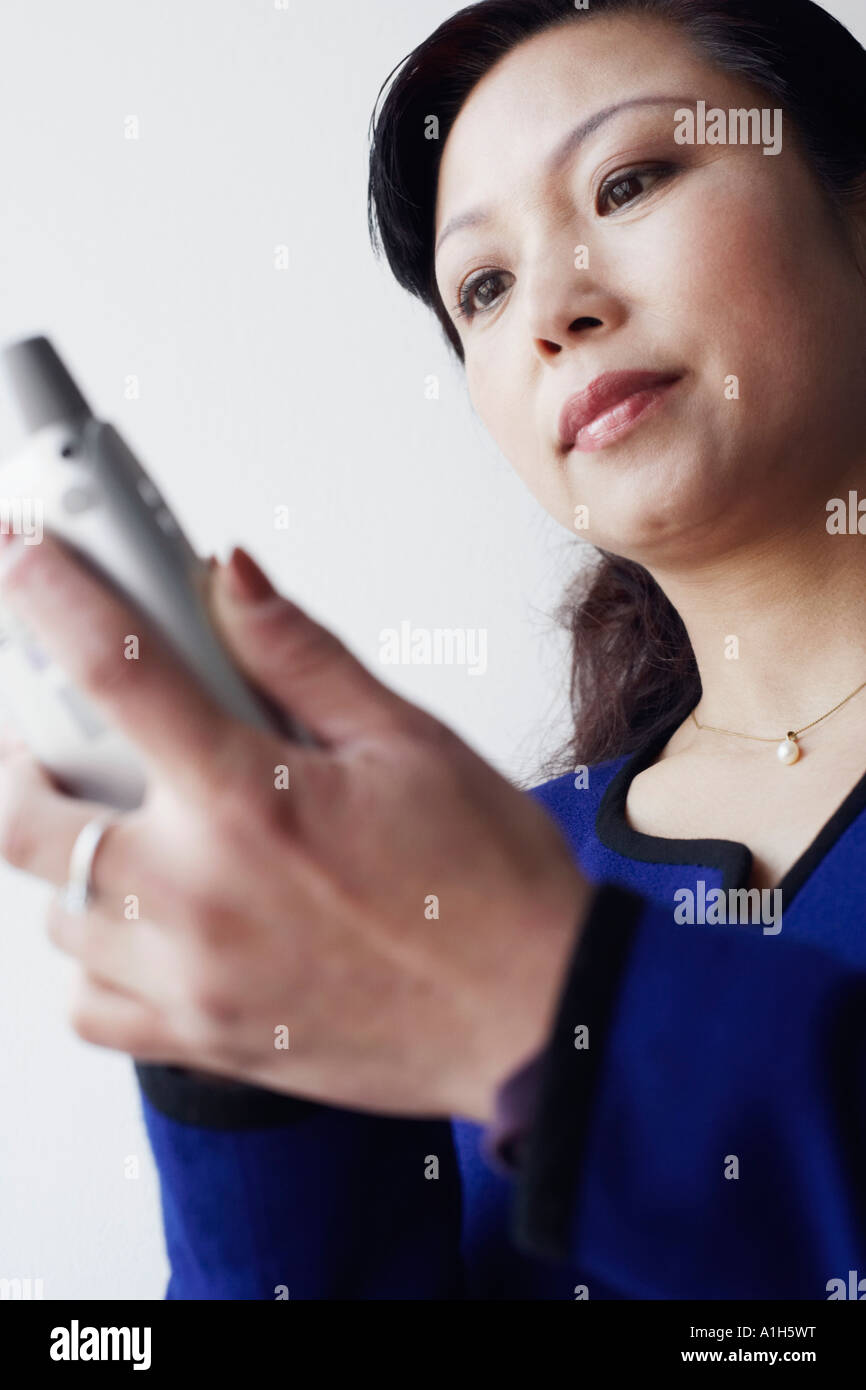 Low angle view of a mature woman operating a mobile phone Stock Photo ...