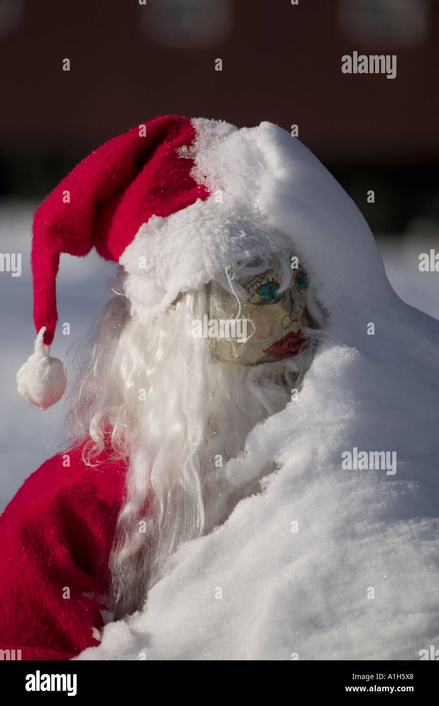 A Santa half covered with snow Stock Photo - Alamy