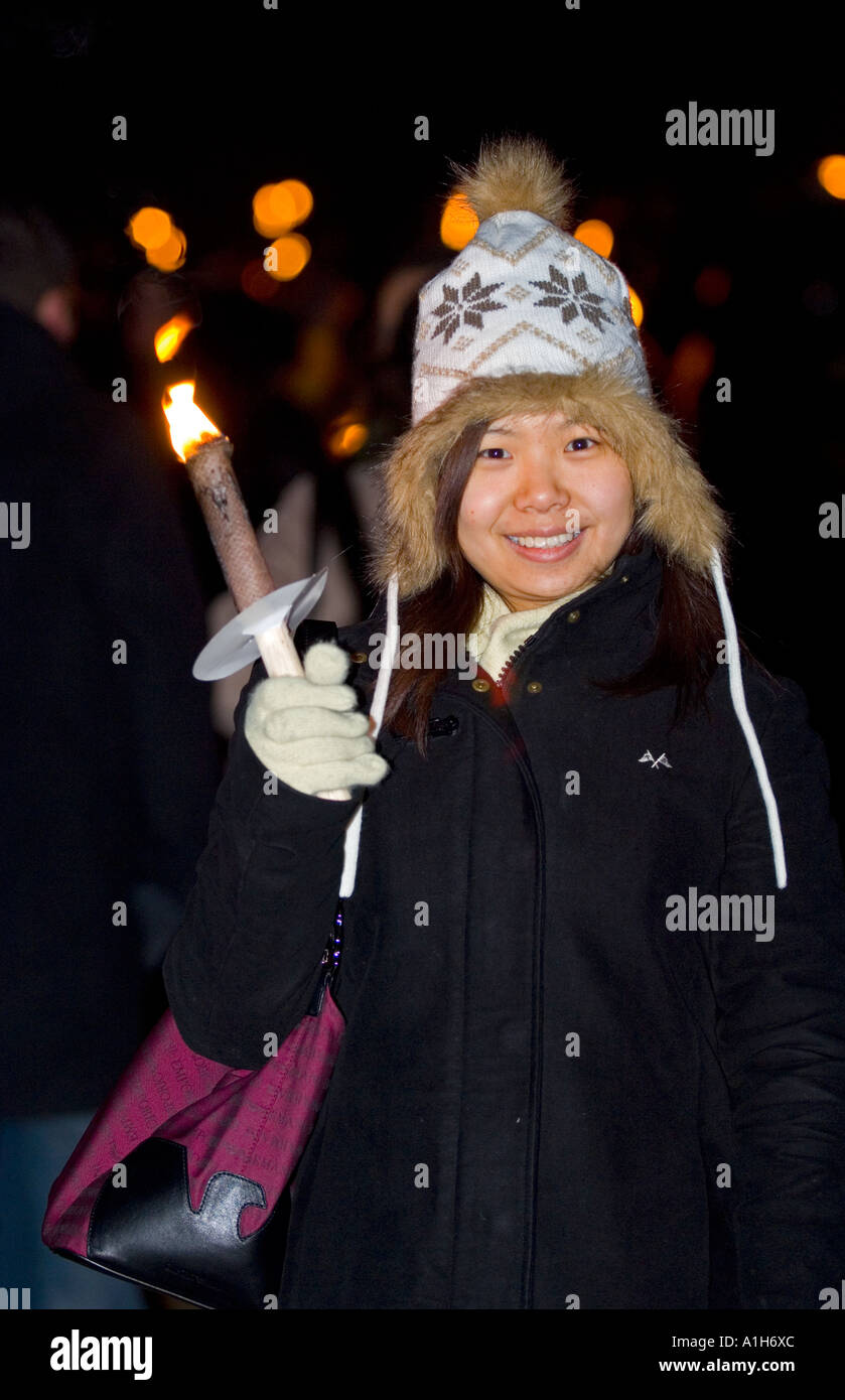 Chinese girl wearing woolly hat at torchlight procession Stock Photo ...