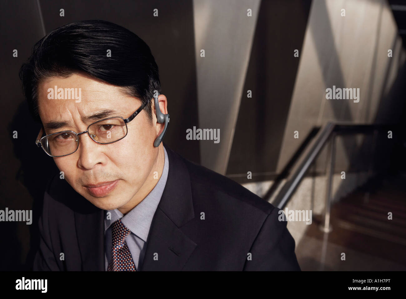 Portrait of a businessman looking serious Stock Photo - Alamy