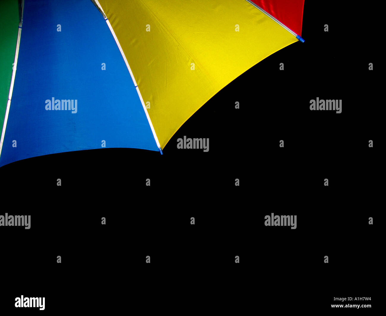 Multi coloured golf umbrella at night Stock Photo - Alamy