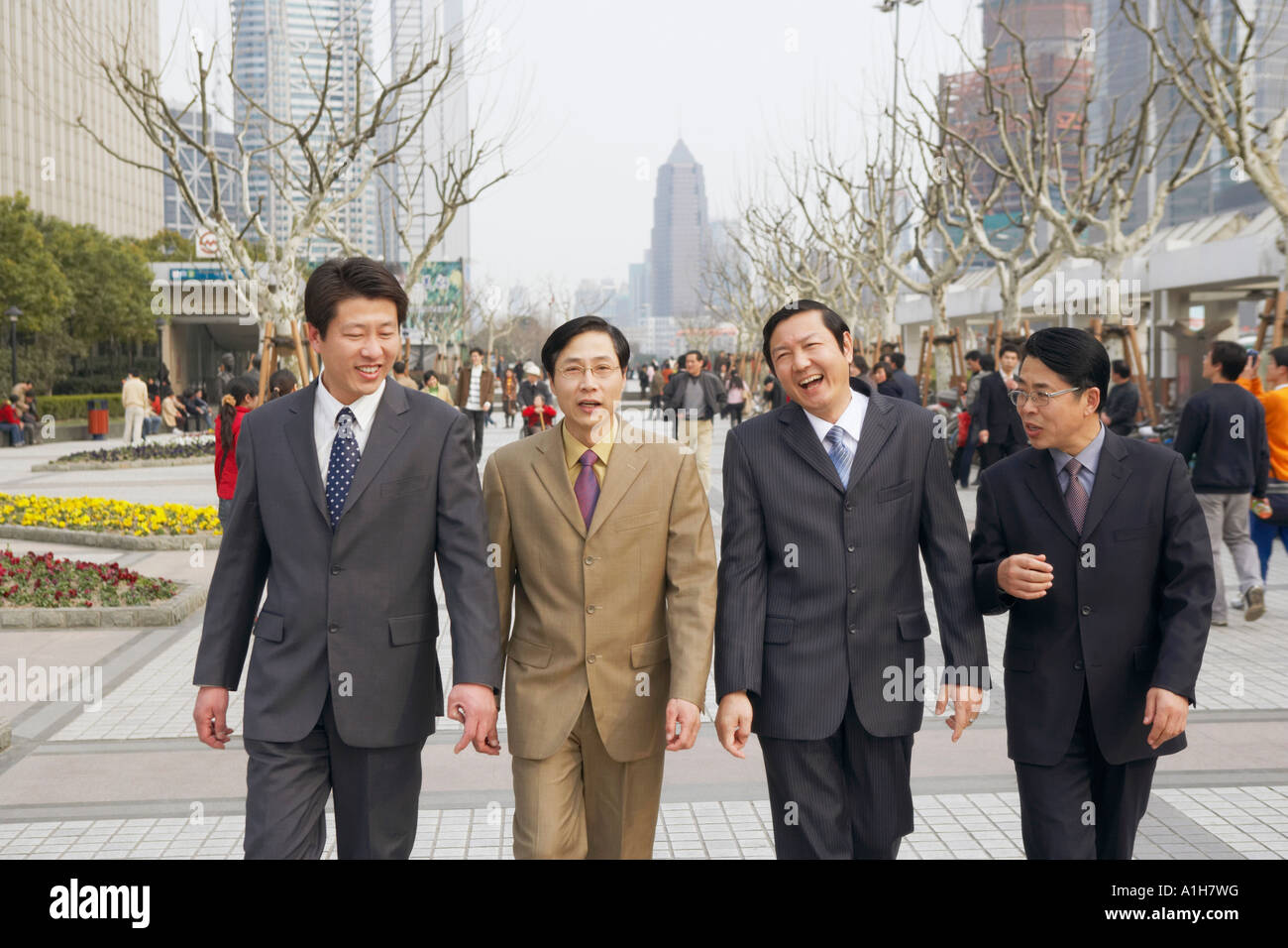 Four businessmen walking together Stock Photo - Alamy